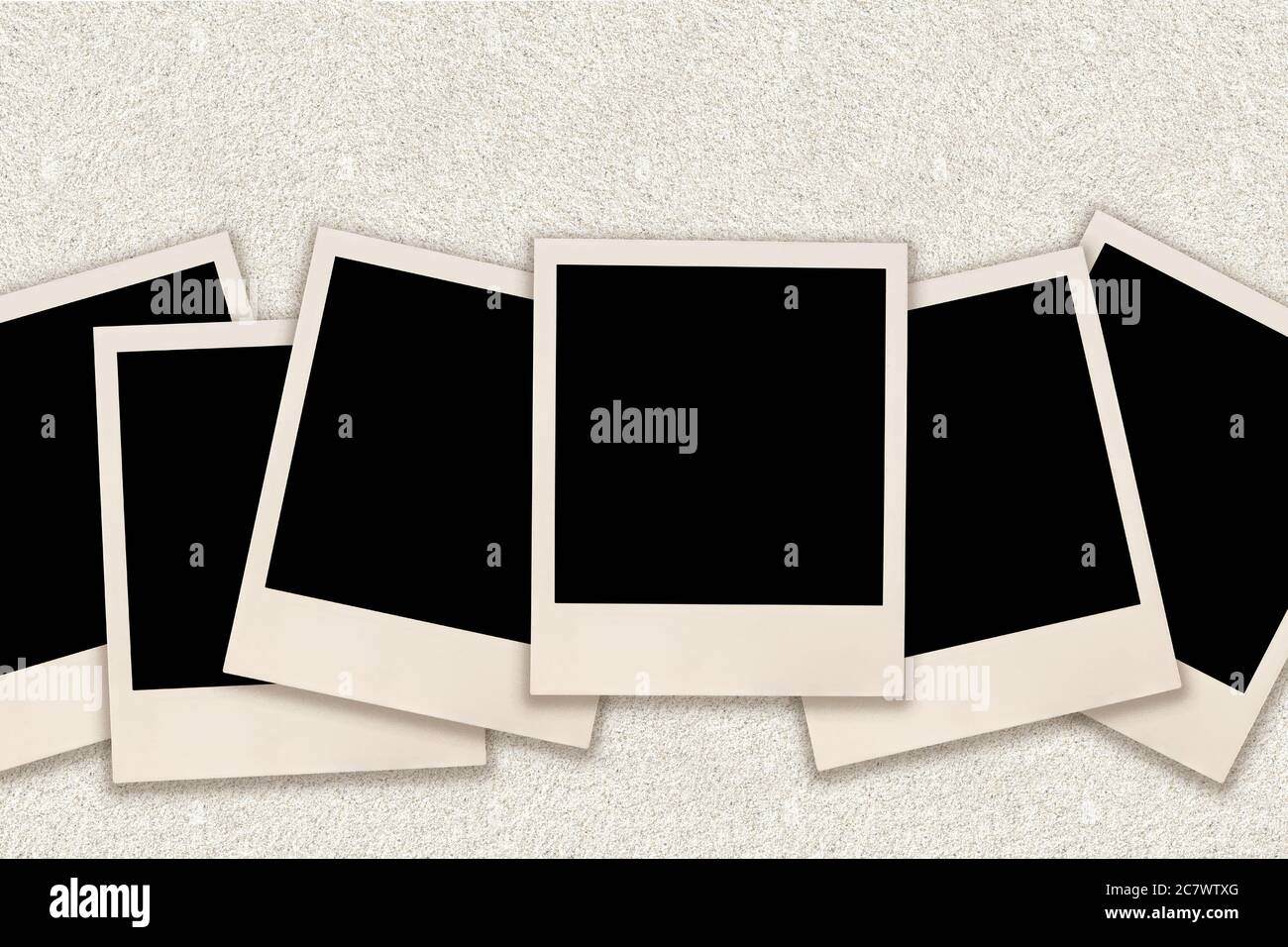 Blank instant images over grunge wall background Stock Photo - Alamy