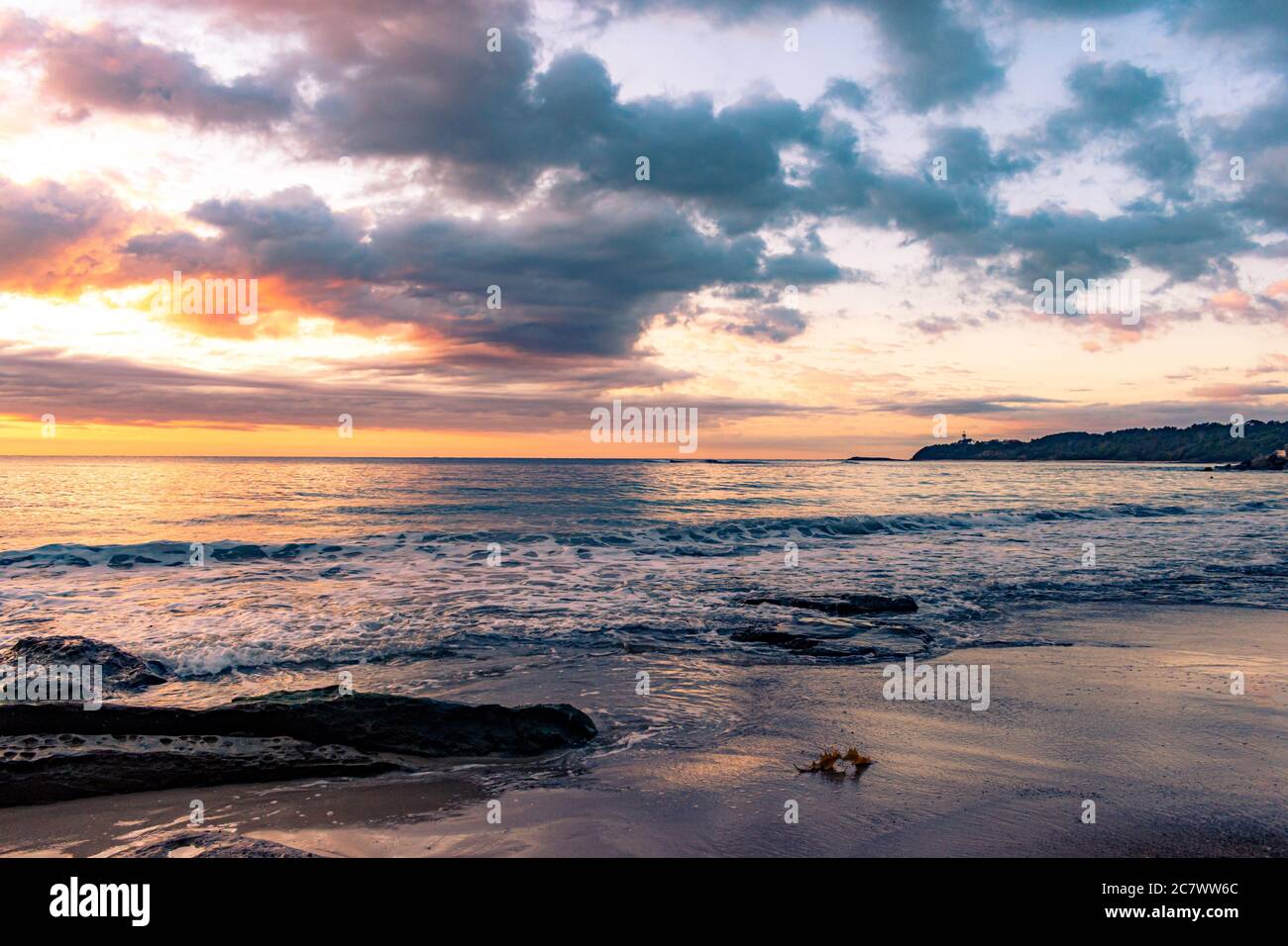 Breathtaking scenery of a sandy beach on a beautiful sunset background ...
