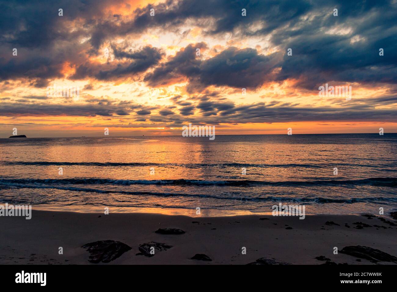Breathtaking scenery of a sandy beach on a beautiful sunset background ...