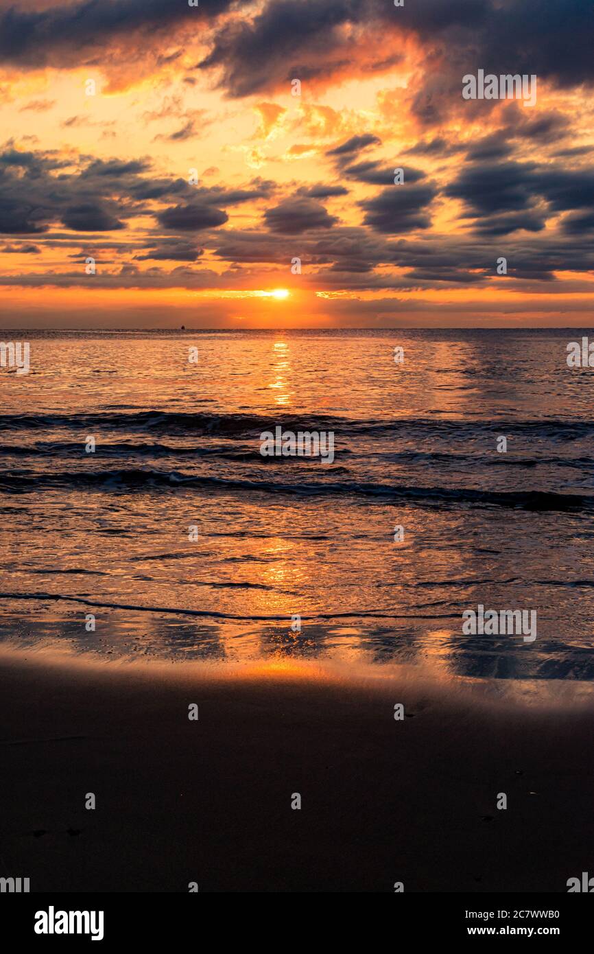 Breathtaking scenery of a sandy beach on a beautiful sunset background ...