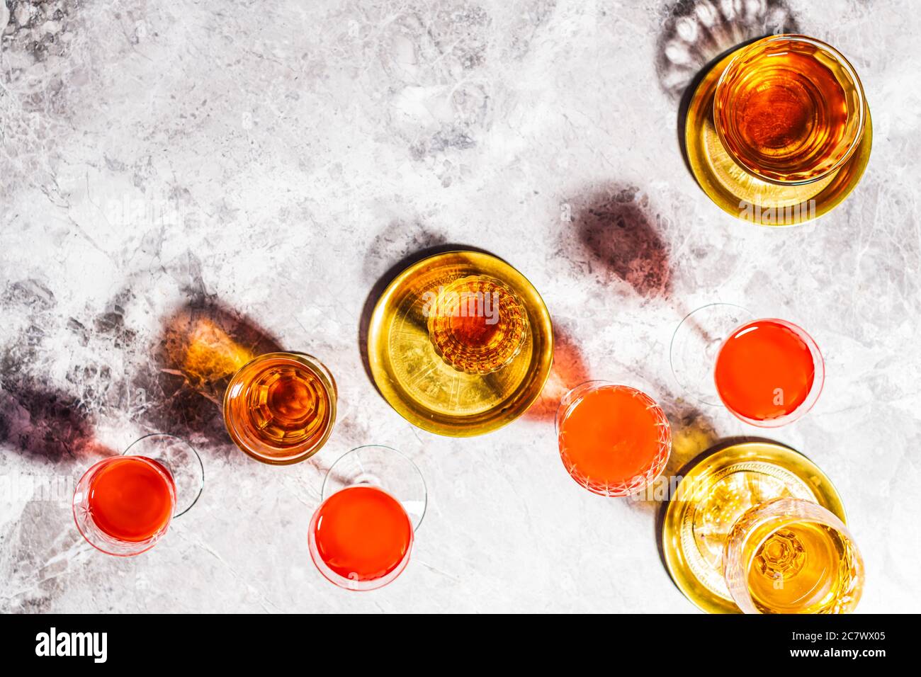 Overhead shot of glasses filled with different drinks on a glass ...