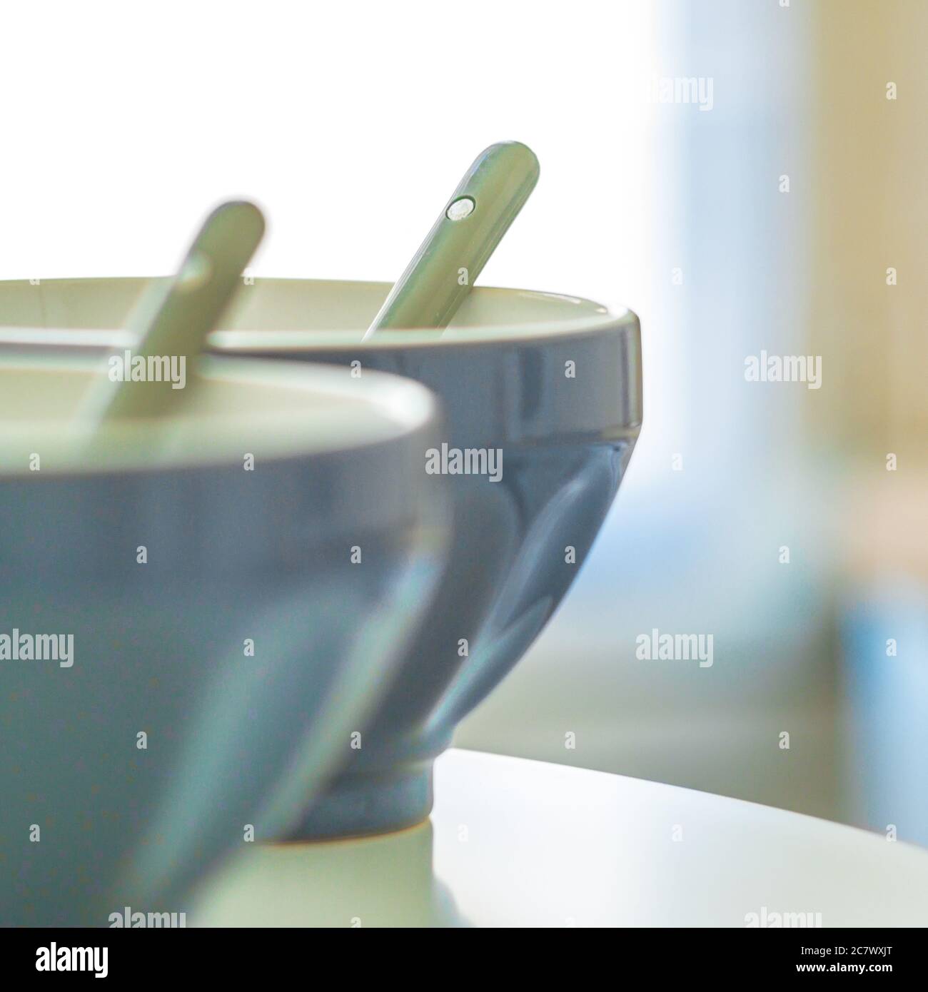 Closeup shot of spoons inside blue bowls Stock Photo - Alamy