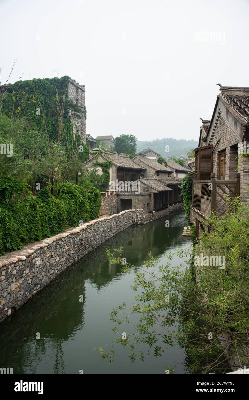 Small and touristic medieval european village on the bank of a river ...
