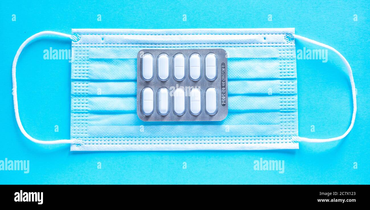 Health care prevention medical tablets pills on face mask stock photo ...