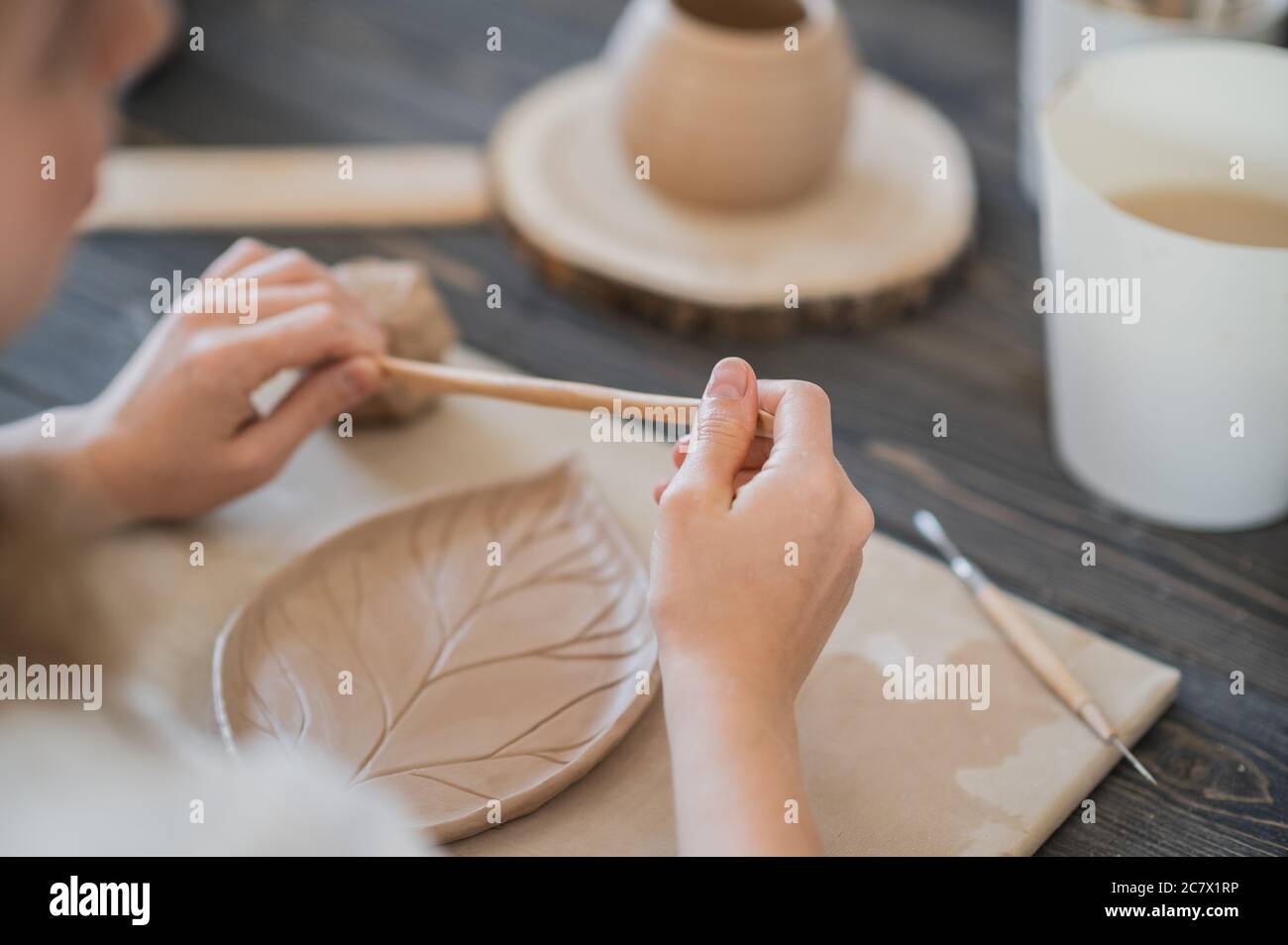 Woman decorating plate handmade hi-res stock photography and images - Alamy