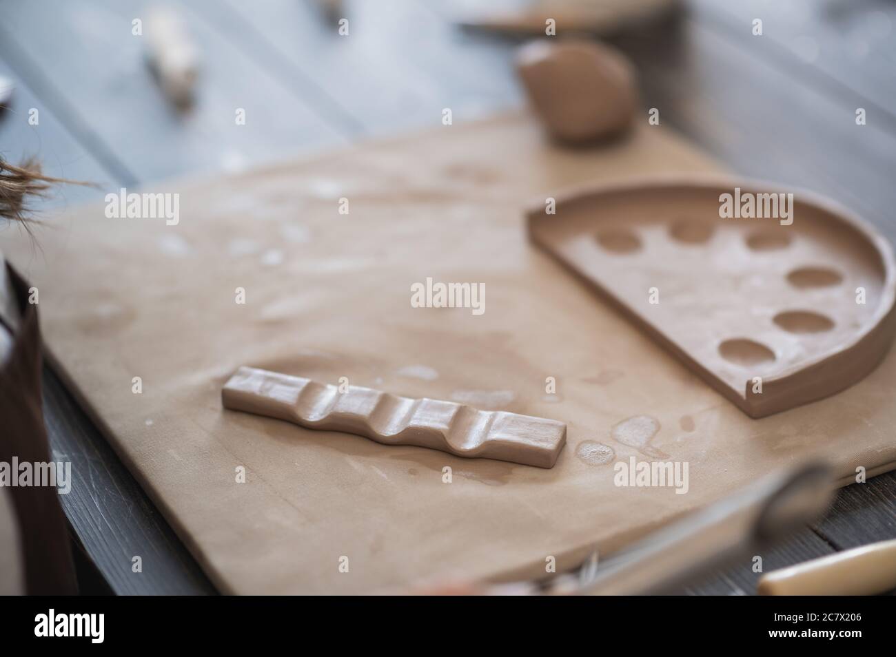 Professional female potter shaping and carving parts pottery workshop ...