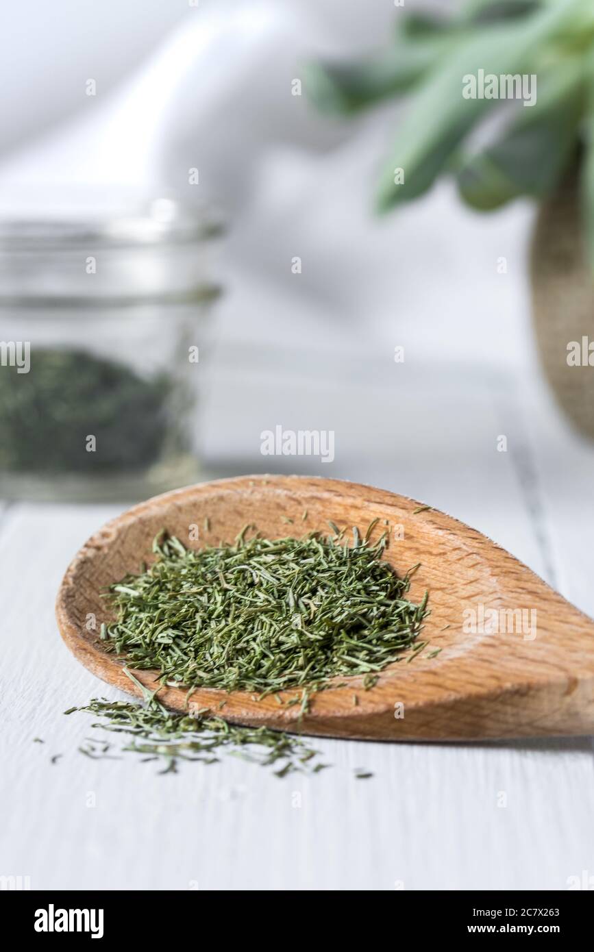 Dried Dill Weed Spilled from a Wood Spoon Stock Photo - Alamy