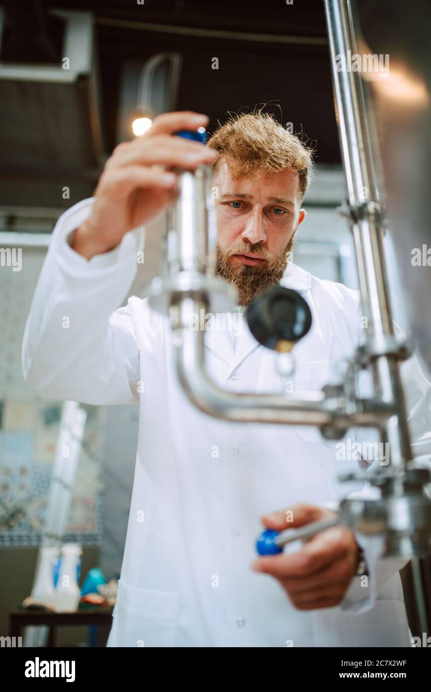 Professional caucasian technologist expert controlling industrial ...