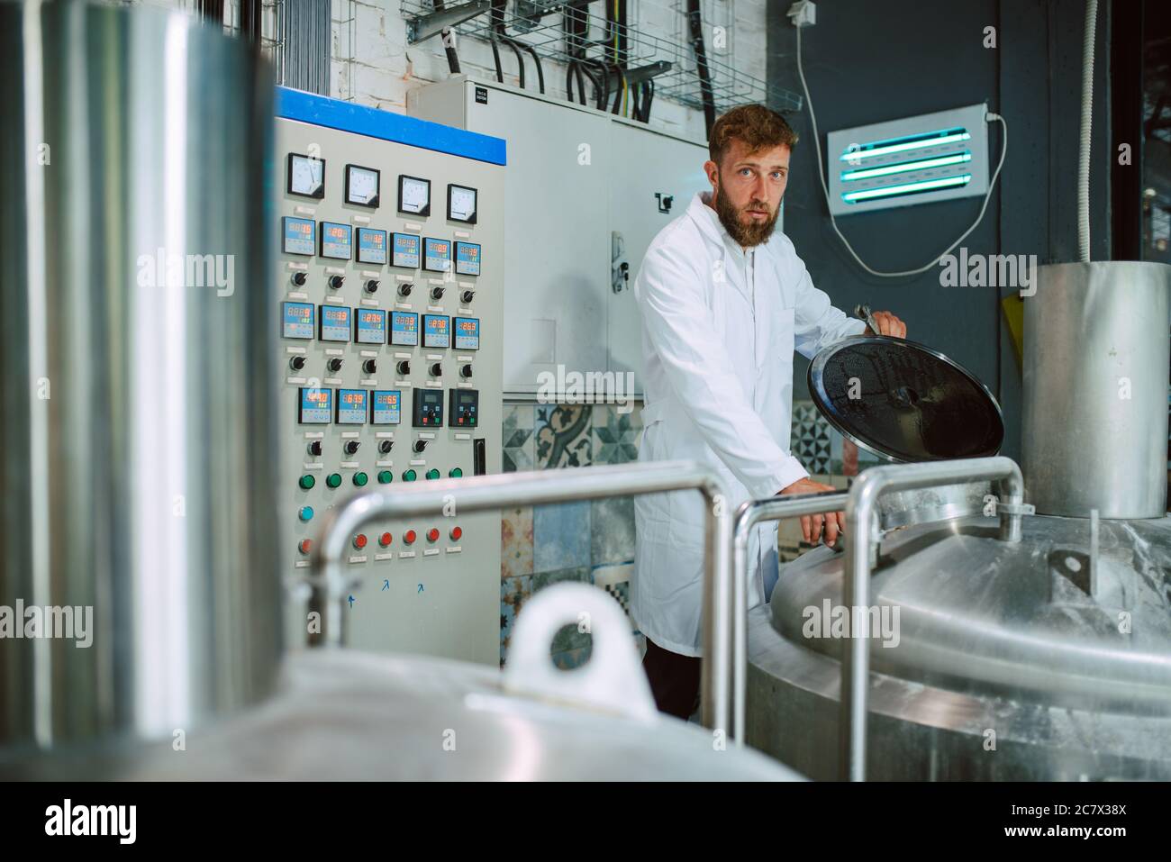 Professional caucasian technologist expert controlling industrial ...