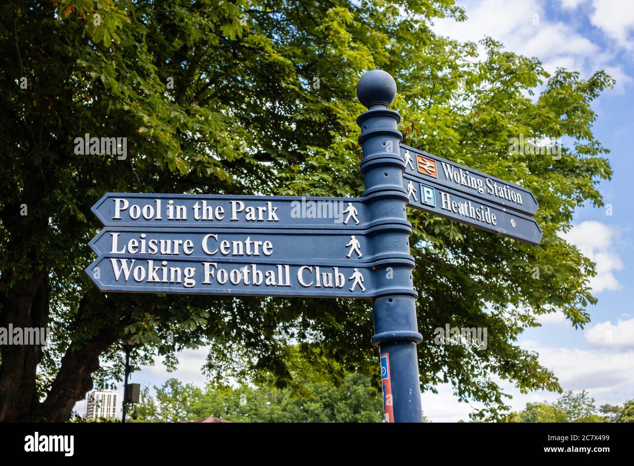 Signpost in Woking Park pointing to local attractions, places of ...