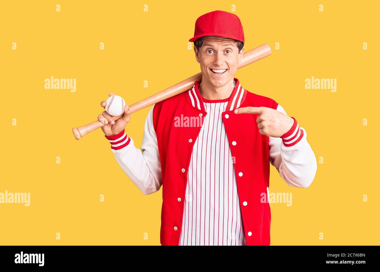 Young handsome man playing baseball holding bat and ball smiling happy ...