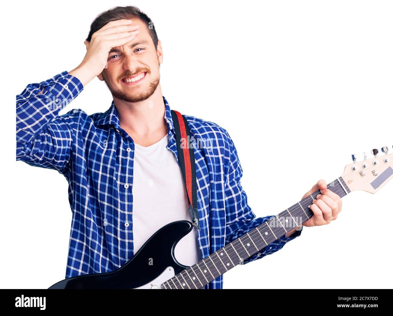 Young handsome caucasian man playing electric guitar stressed and ...