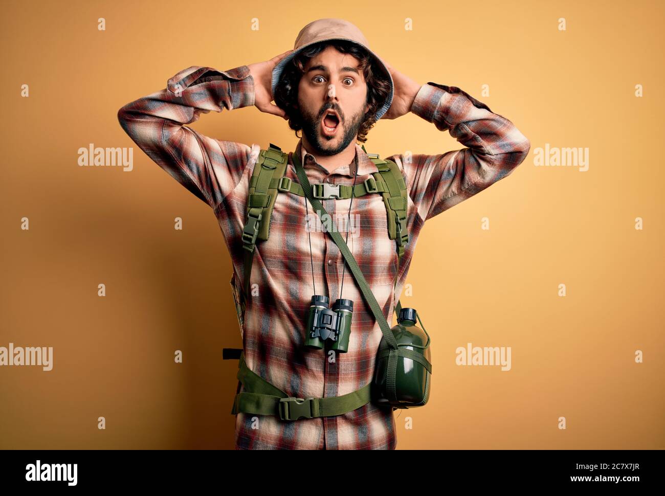 Young hiker man with curly hair and beard hiking wearing backpack and ...