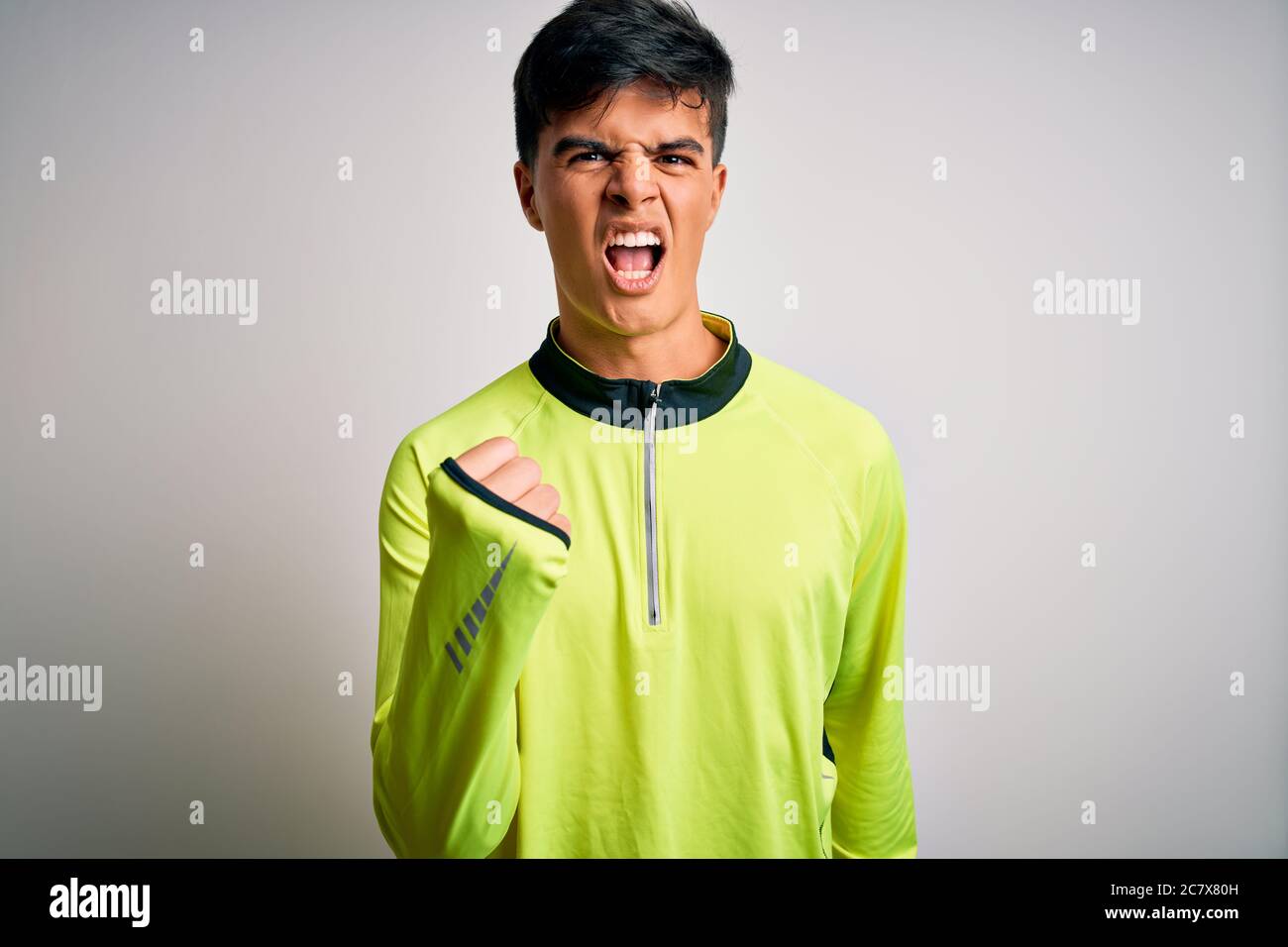 Young handsome sportsman doing sport wearing sportswear over isolated ...