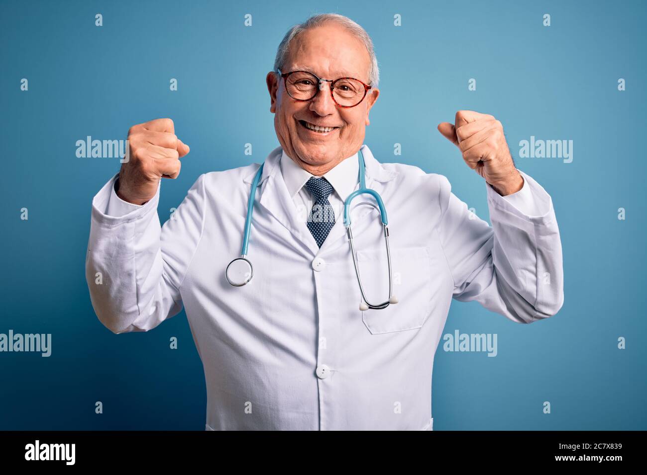 Senior grey haired doctor man wearing stethoscope and medical coat over ...