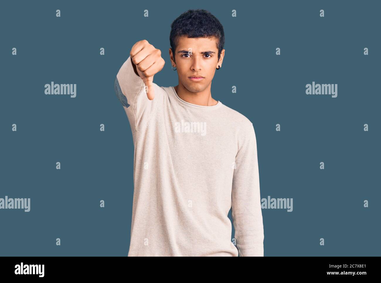 Young african amercian man wearing casual clothes looking unhappy and ...
