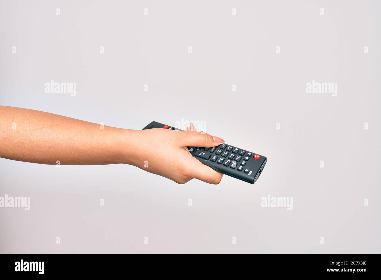 Hand of caucasian young woman changing television channel holding tv ...
