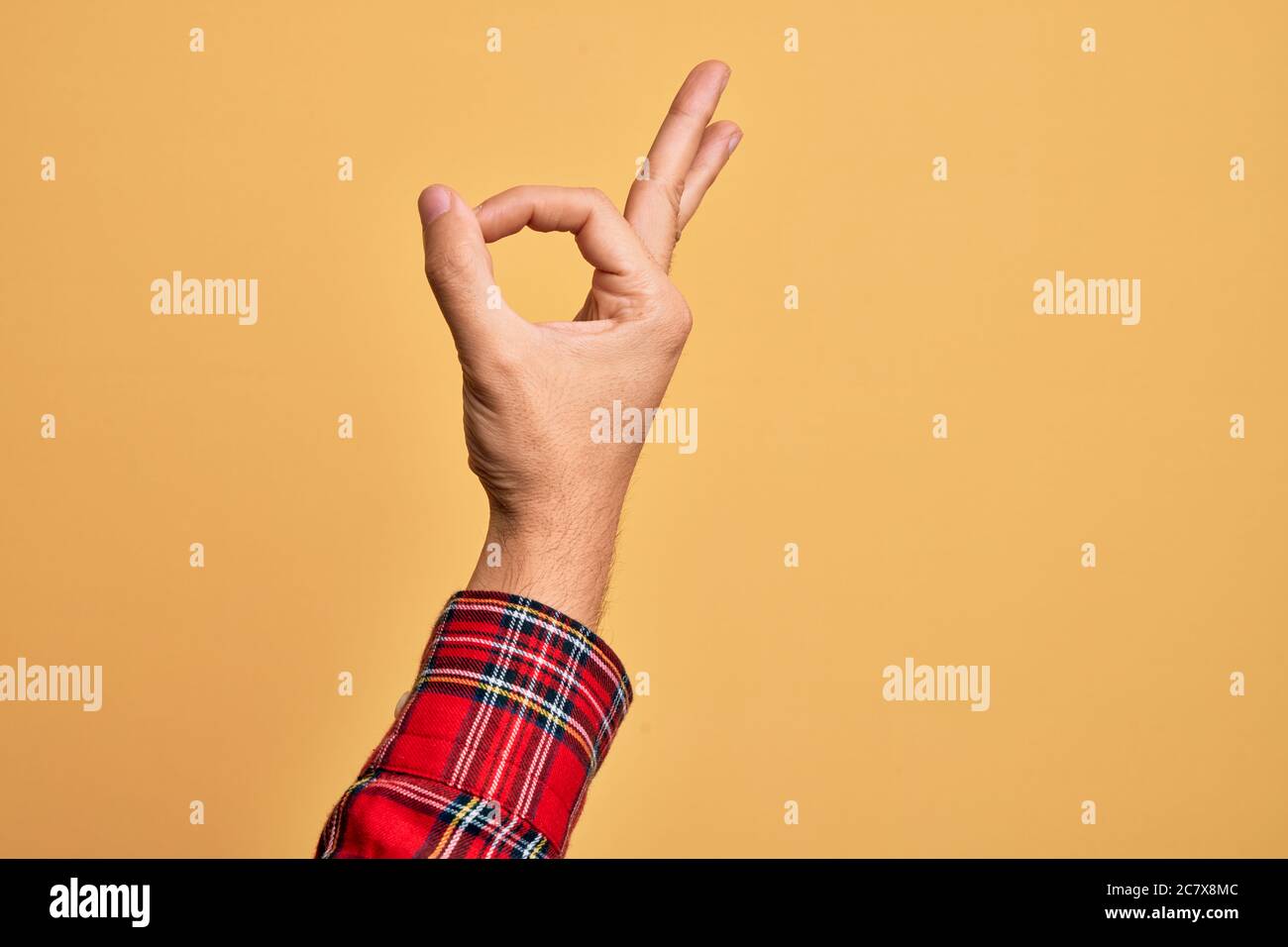 Hand of caucasian young man showing fingers over isolated yellow ...