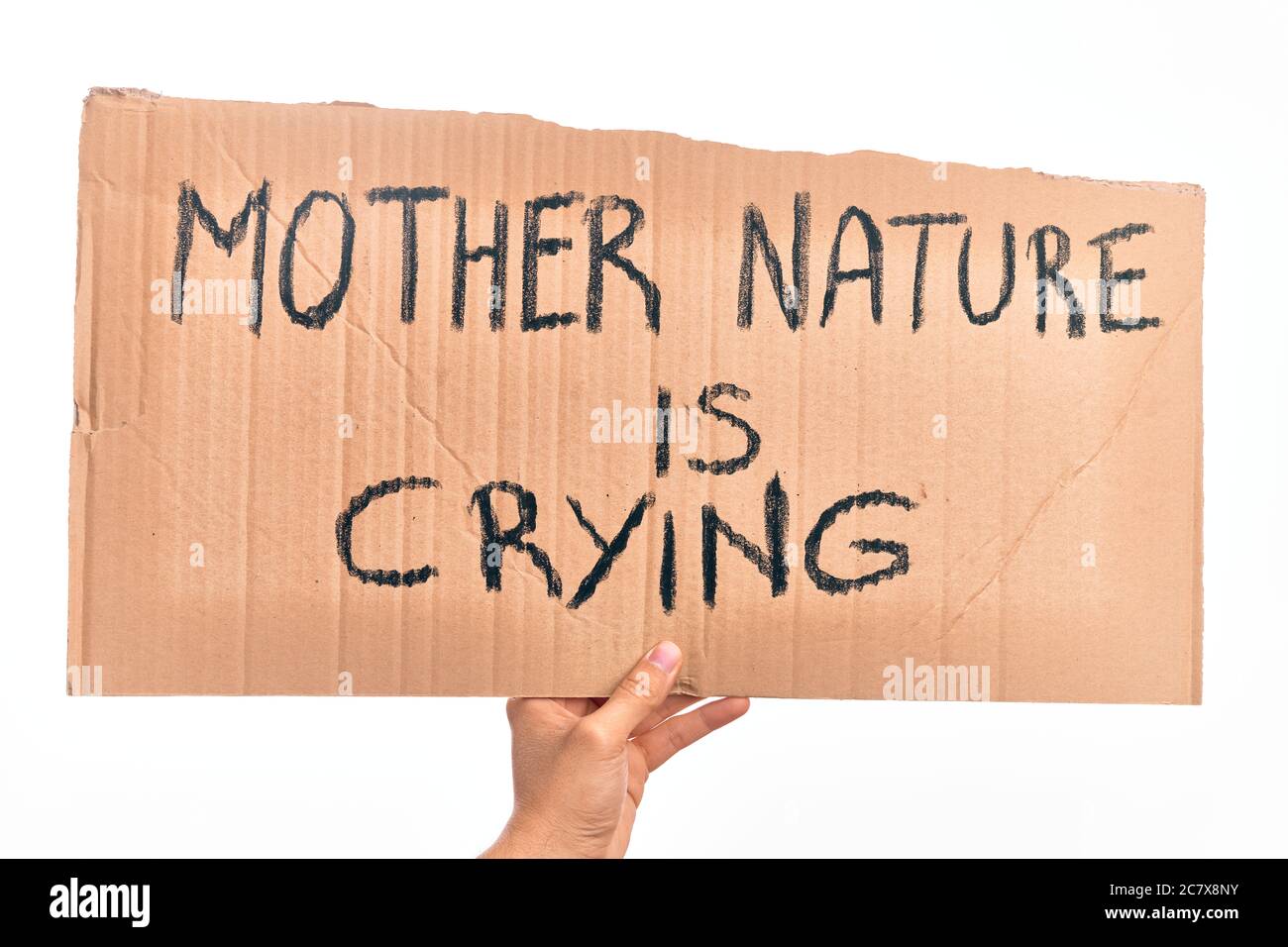 Cardboard banner with MOTHER NATURE IS CRYING text, protesting against ...