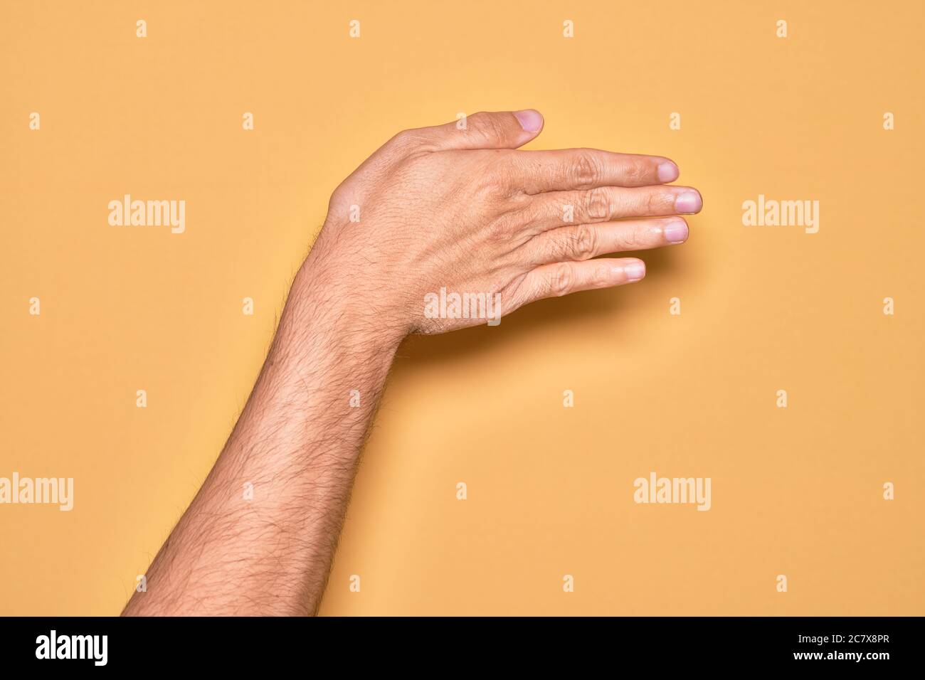 Hand of caucasian young man showing fingers over isolated yellow ...