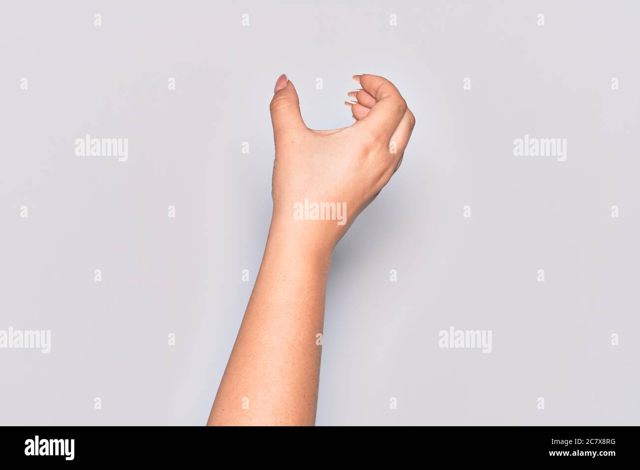 Hand of caucasian young woman holding invisible object, empty hand ...