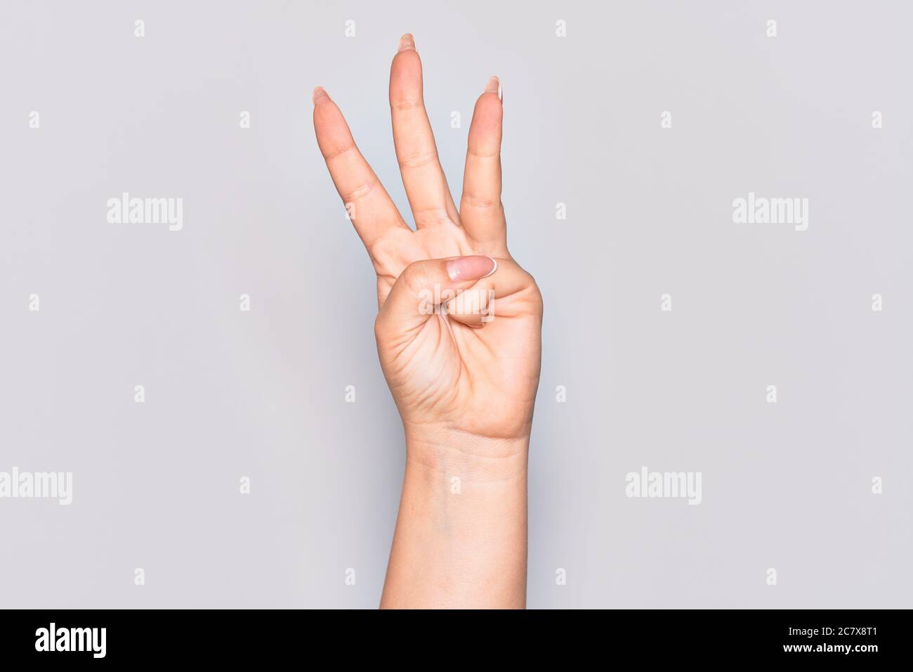 Hand of caucasian young woman counting number 3 showing three fingers Stock Photo - Alamy