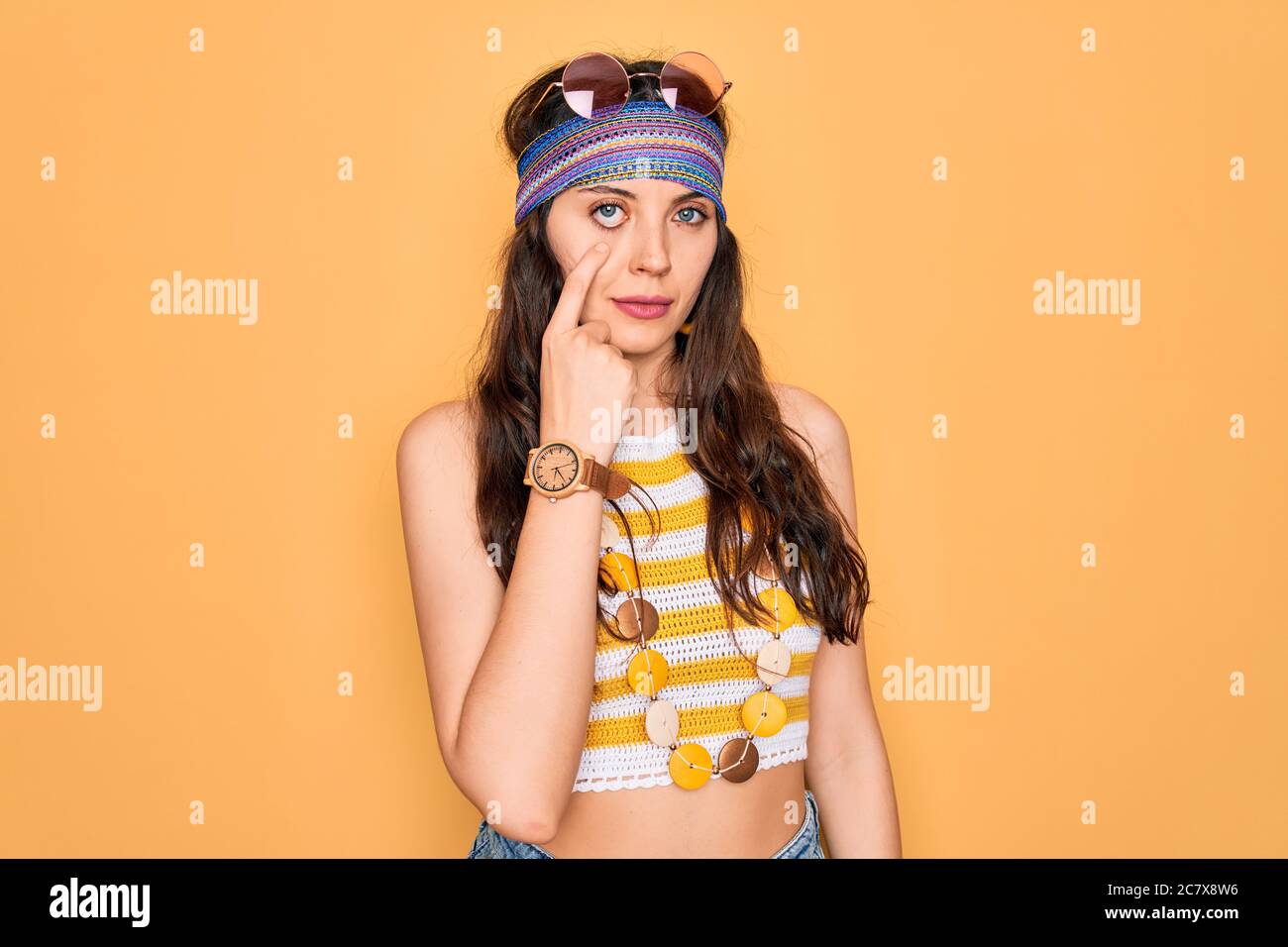 Young beautiful hippie woman with blue eyes wearing accesories and ...