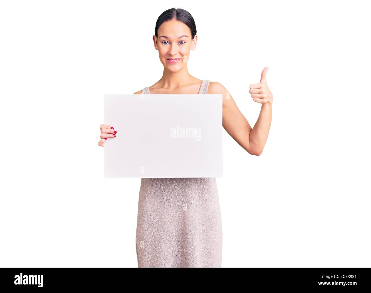 Beautiful brunette young woman holding blank empty banner smiling happy ...