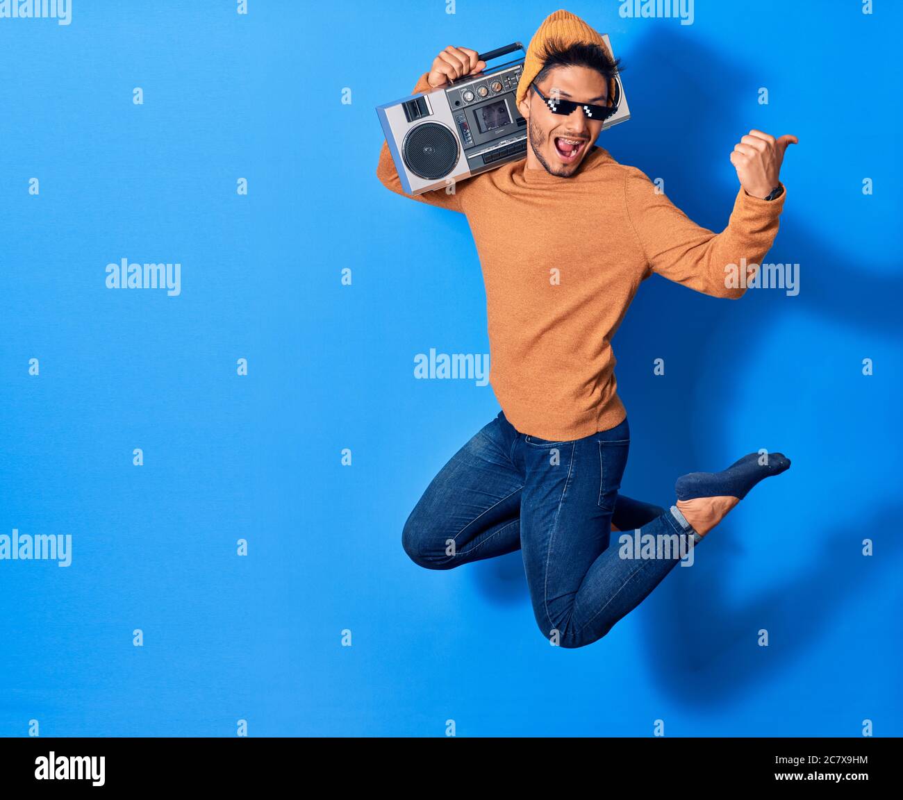 Young handsome latin man smiling happy wearing thug lif sunglasses ...