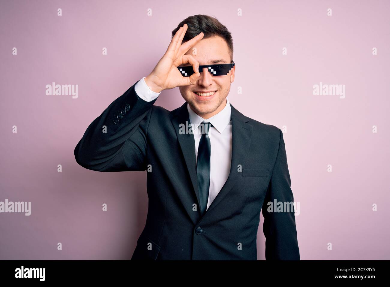 Young handsome caucasian business man wearing funny thug life glasses ...