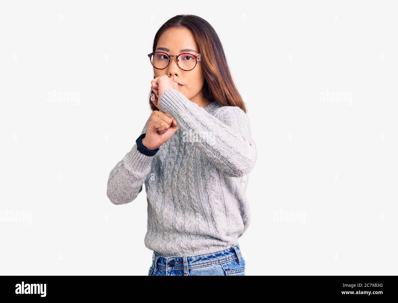 Young beautiful chinese girl wearing casual clothes ready to fight with ...