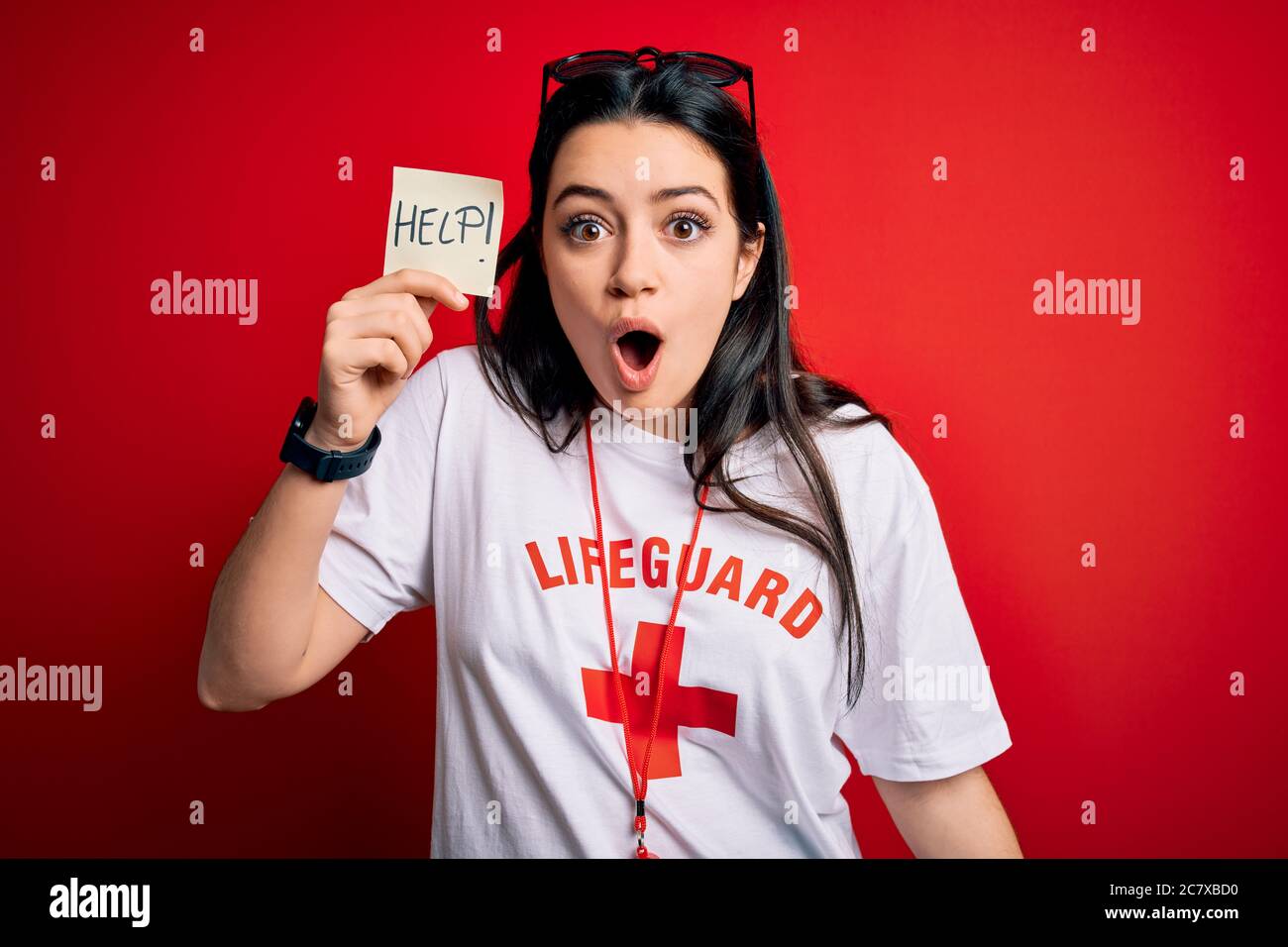 Young lifeguard woman holding paper note with help word over red ...