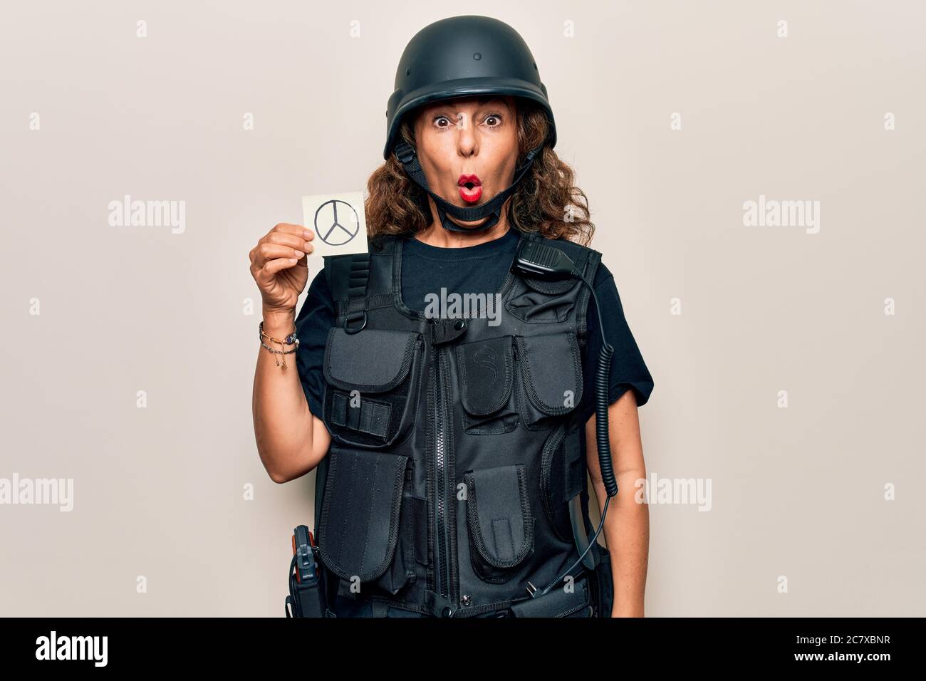 Middle age soldier woman wearing uniform and security helmet holding ...