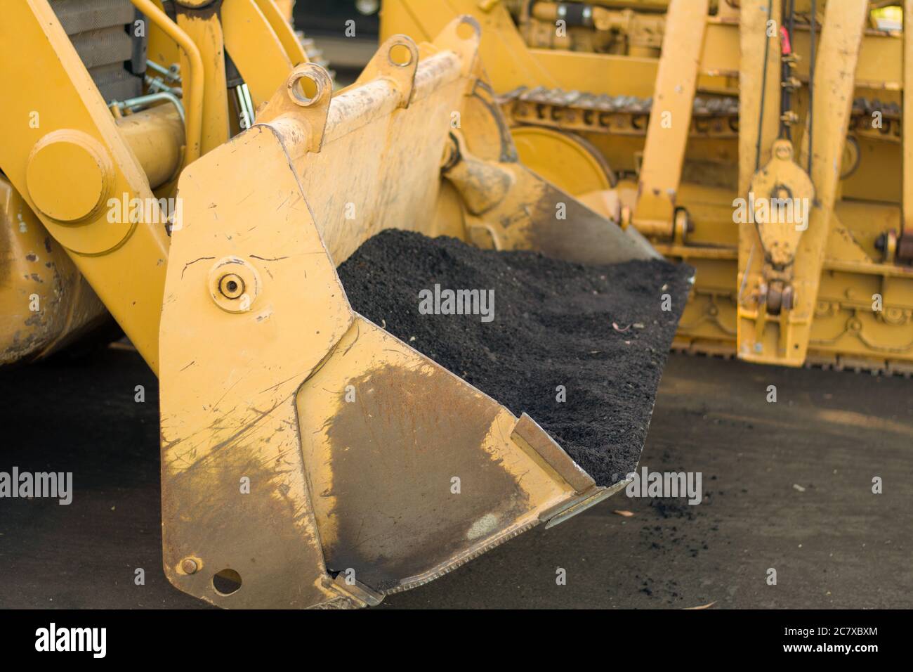 Backhoe loader with asphalt Stock Photo - Alamy