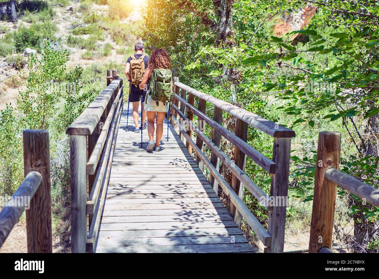 Beautiful couple of hiker wearing explorer clothes and backpack ...