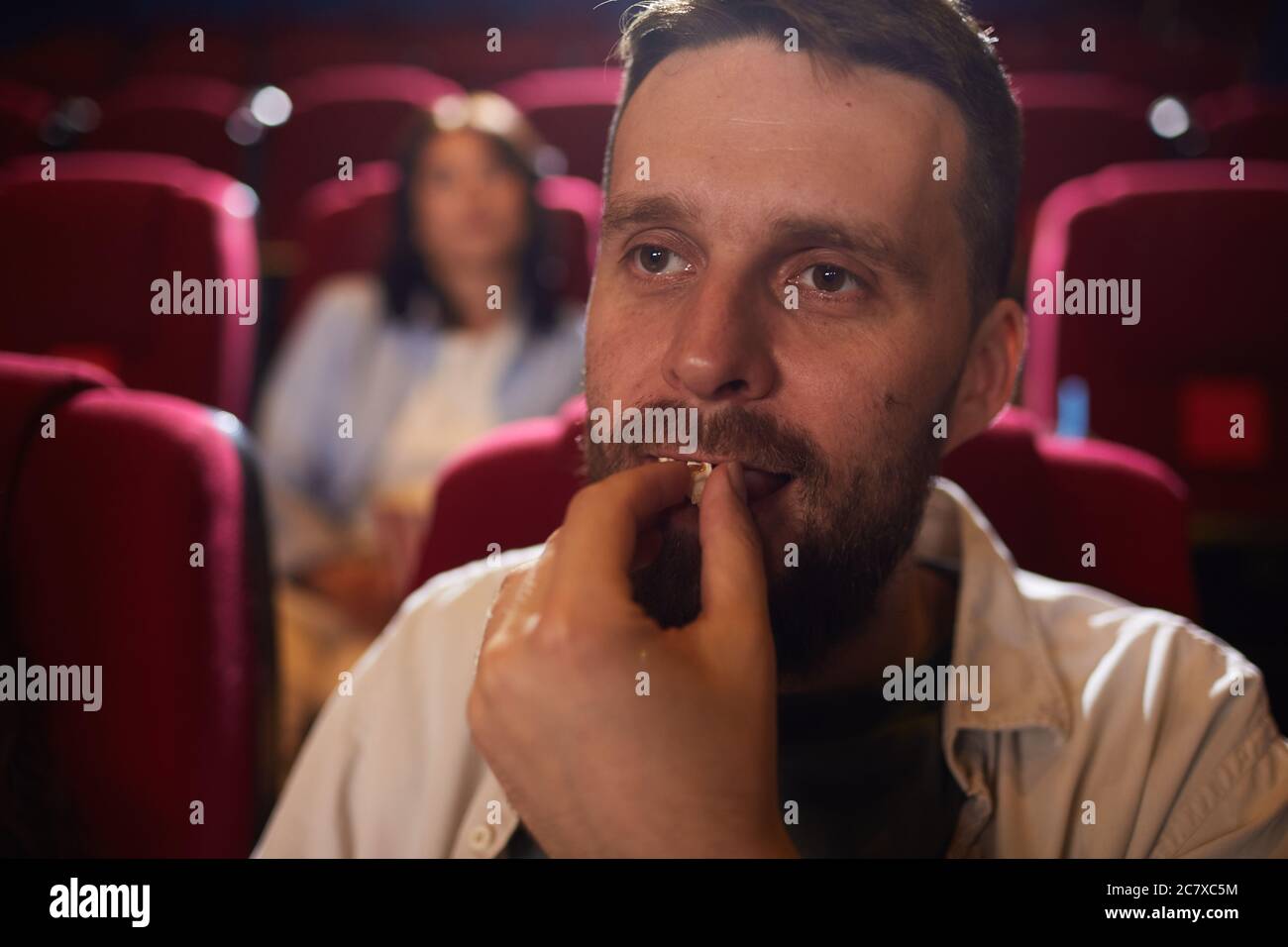 Man eating popcorn hi-res stock photography and images - Alamy