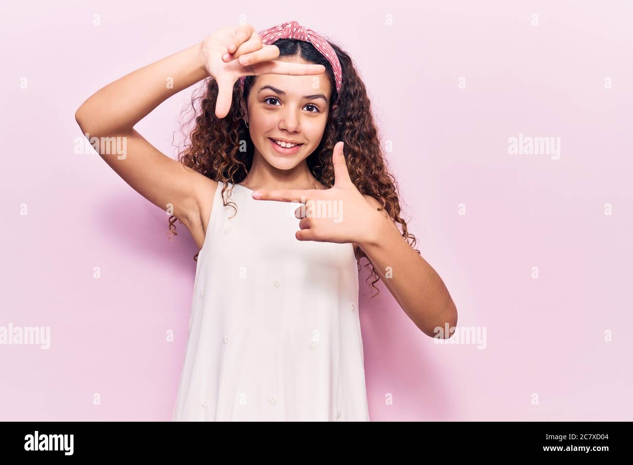 Beautiful kid girl with curly hair wearing casual clothes smiling ...