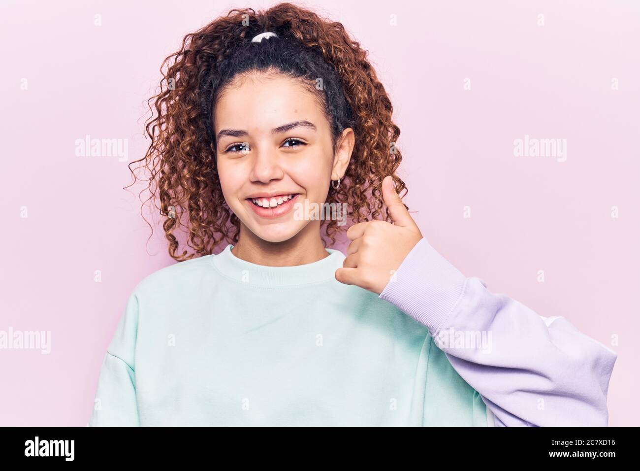 Beautiful kid girl with curly hair wearing casual clothes smiling happy ...