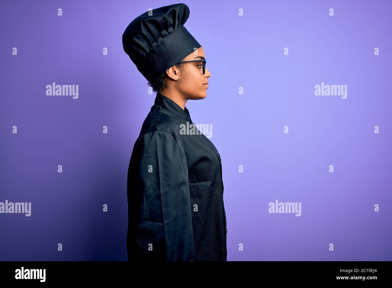Young african american chef girl wearing cooker uniform and hat over ...