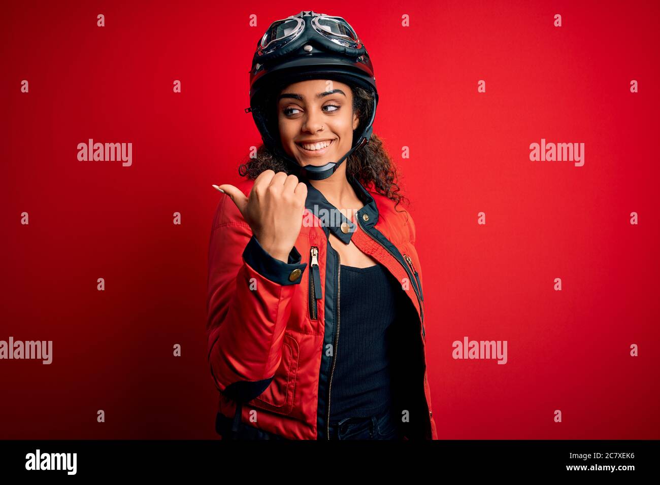 Young african american motorcyclist girl wearing moto helmet and ...