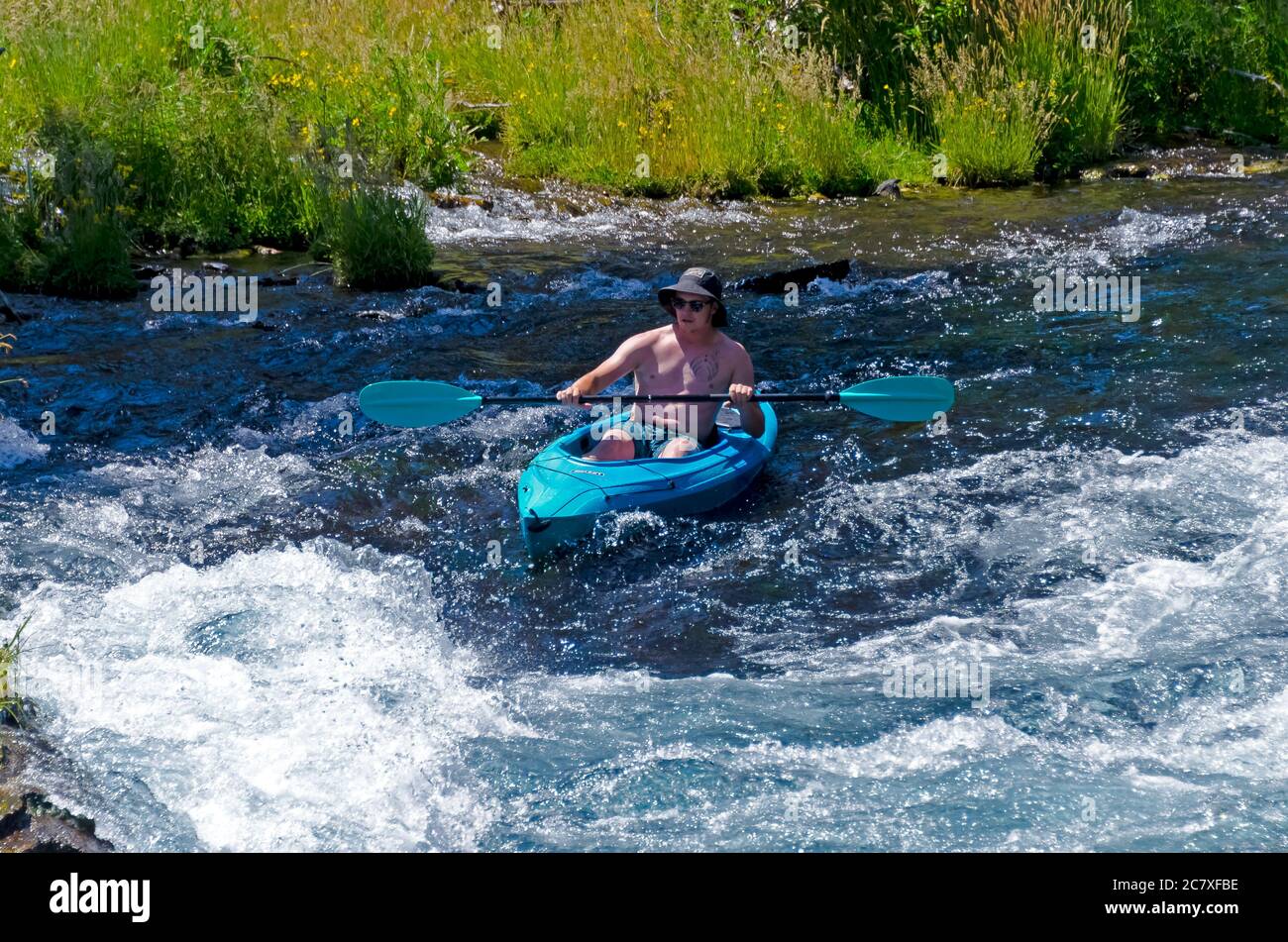Kayak tipping over while going over the rapids Stock Photo - Alamy