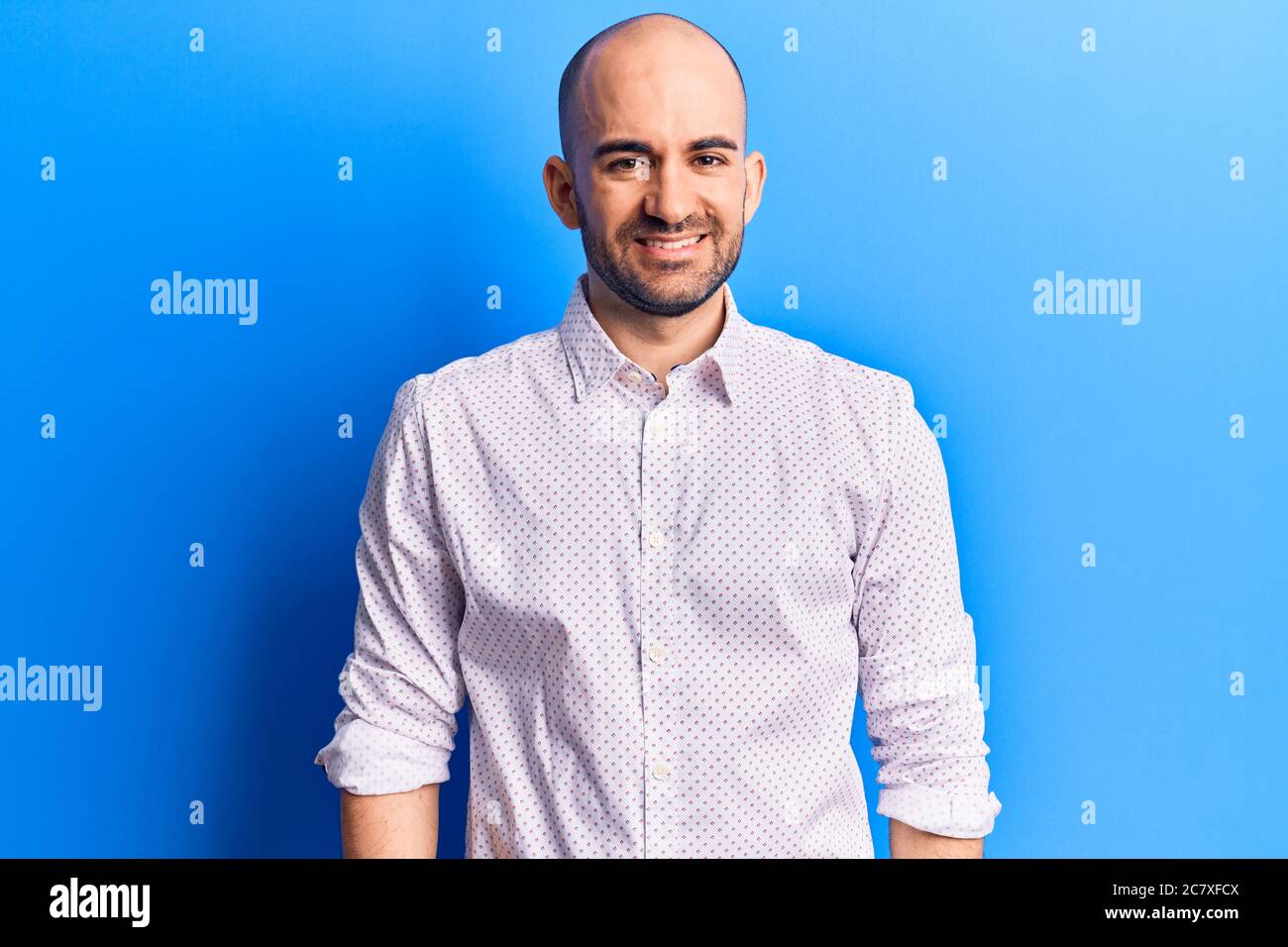 Young handsome bald man wearing elegant shirt with a happy and cool ...