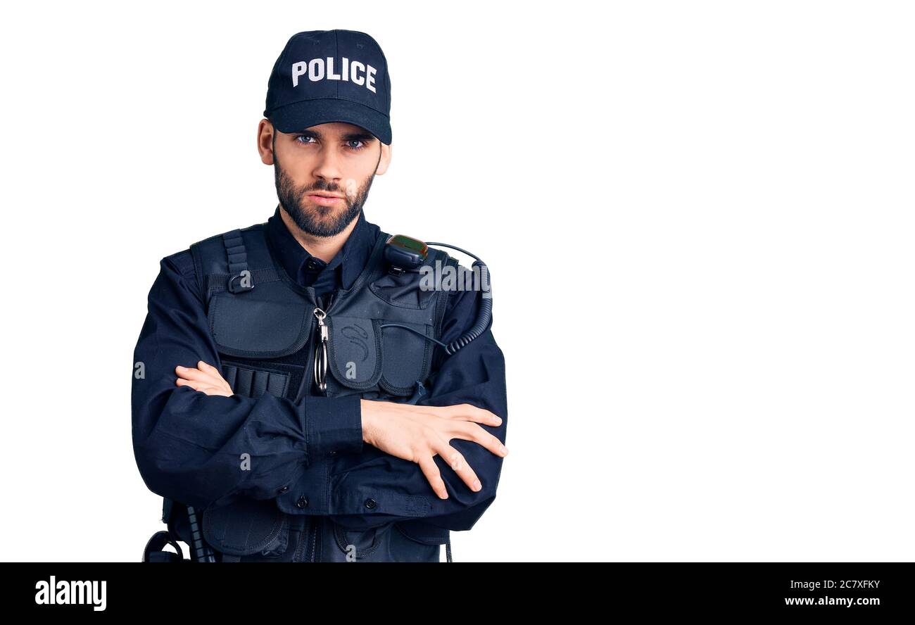 Young handsome man with beard wearing police uniform skeptic and ...