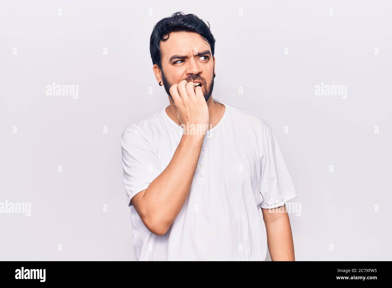 Young hispanic man wearing casual clothes looking stressed and nervous ...