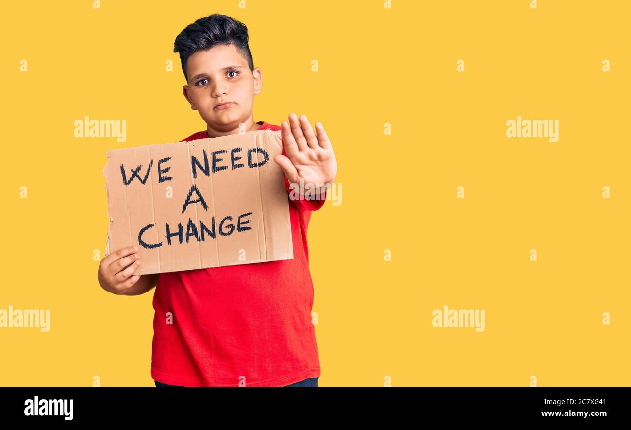 Little boy kid holding we need a change banner with open hand doing ...