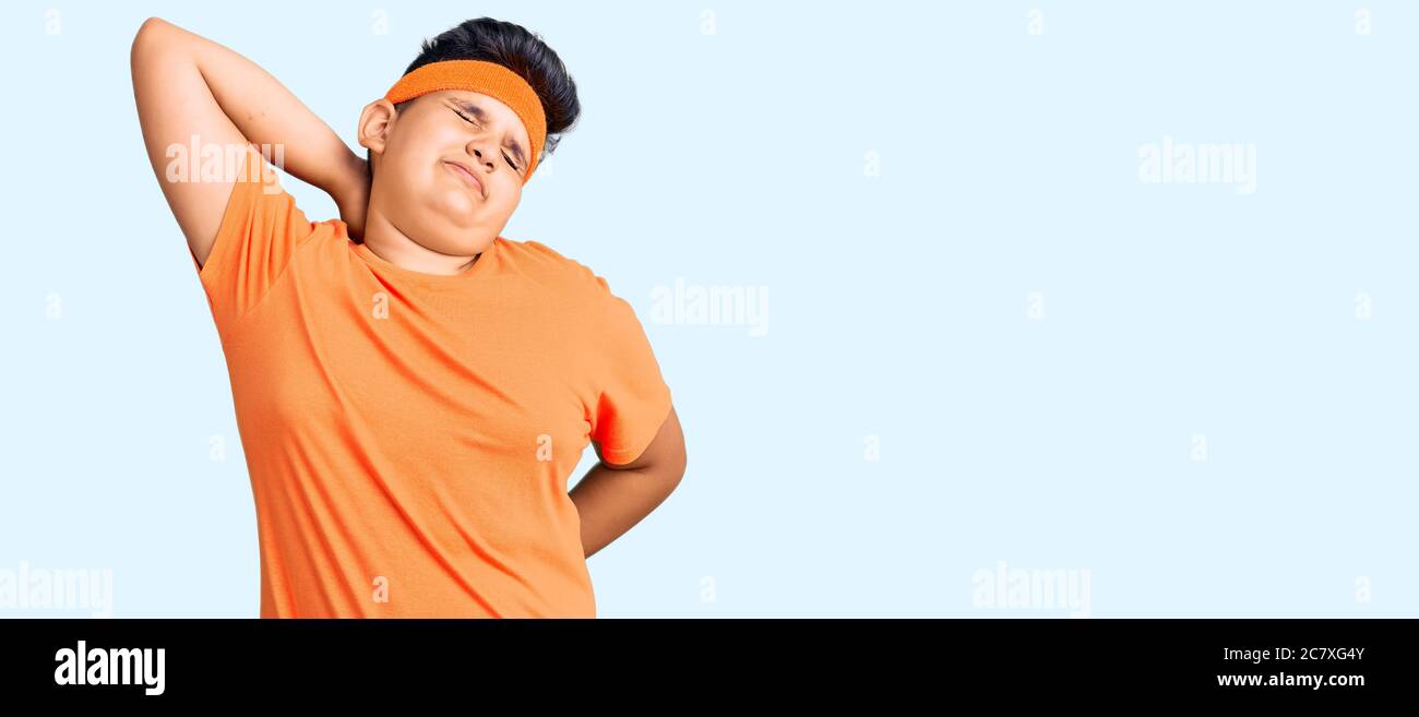 Little boy kid wearing sportswear suffering of neck ache injury ...