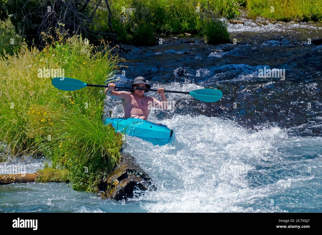 Kayak tipping over while going over the rapids Stock Photo - Alamy