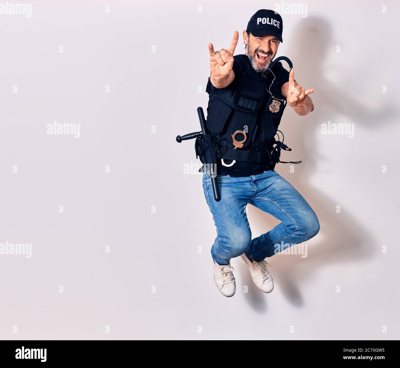 Middle age handsome man wearing police unifrom smiling happy. Jumping ...