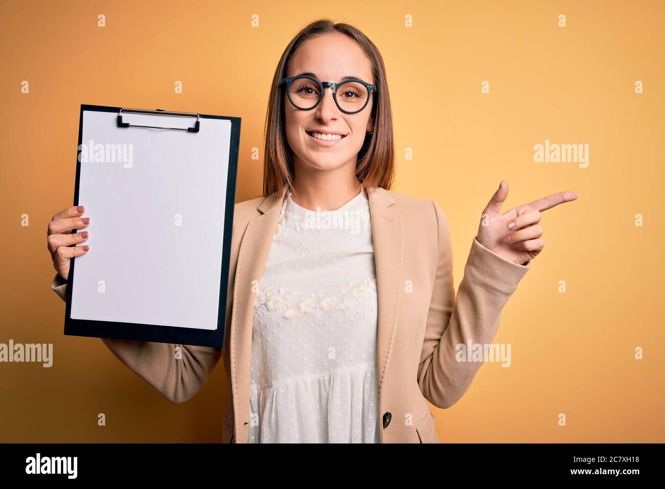 Beautiful inspector woman wearing glasses holding checklist clipboard ...