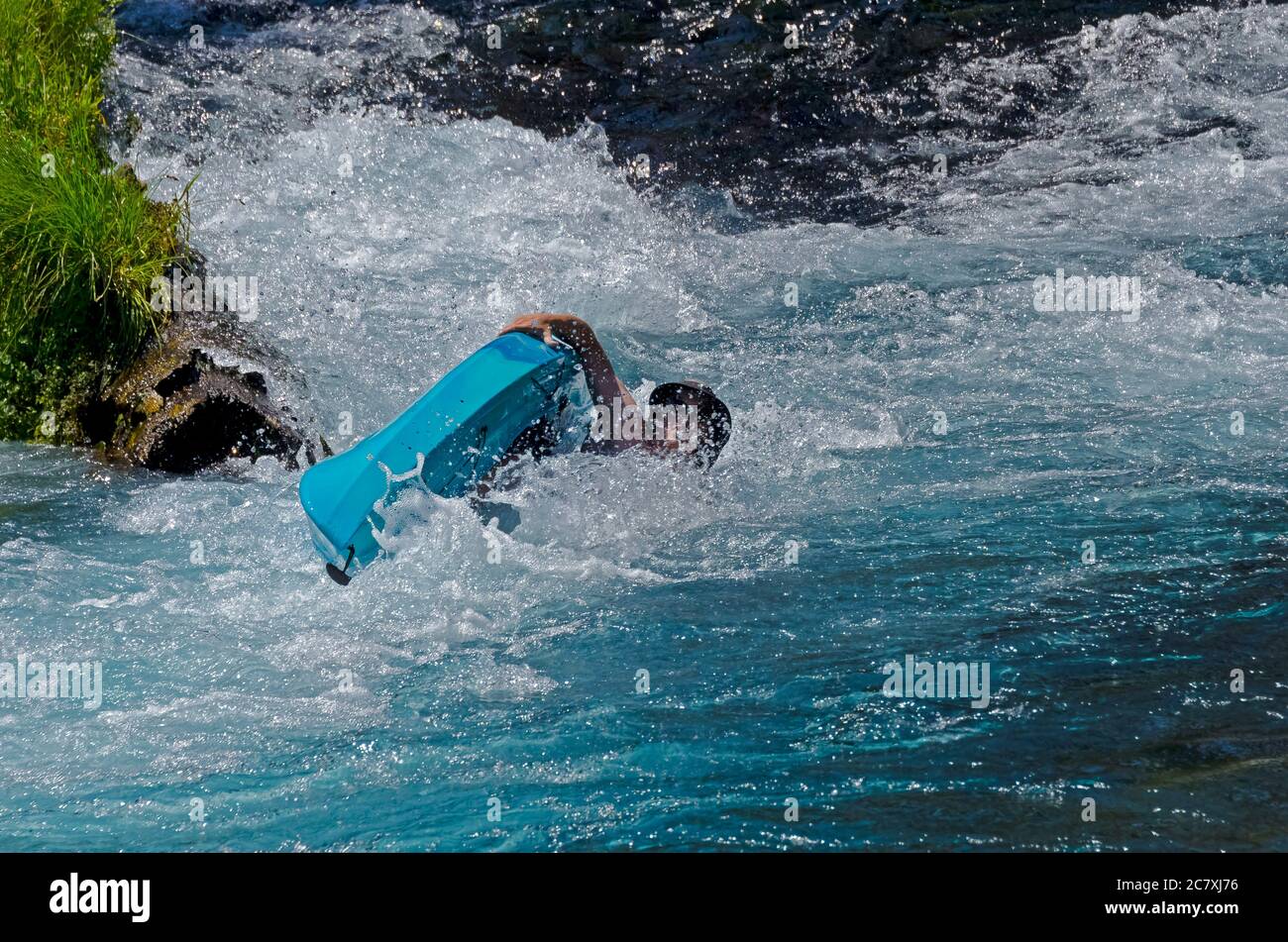 Kayak tipping over while going over the rapids Stock Photo - Alamy